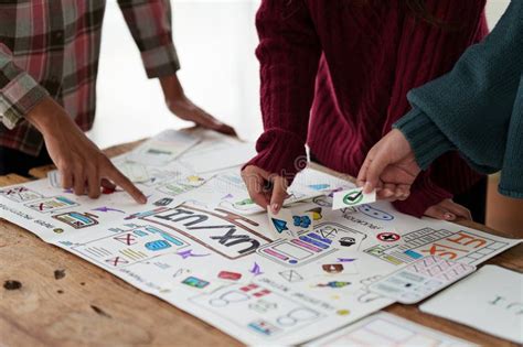close up ux developer and ui designer brainstorming interface wireframe