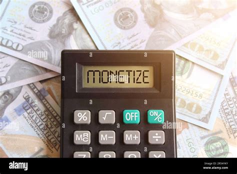 Top View Image Of Calculator With Text Monetize On Display And Money