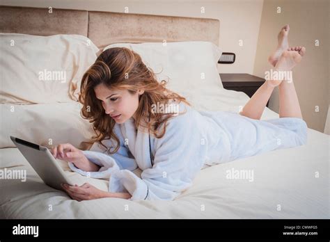 Woman Using Tablet Computer On Bed Stock Photo Alamy