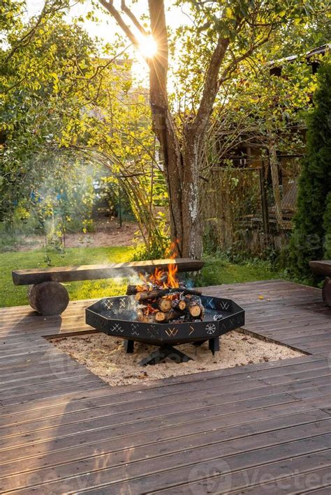 Outdoor Wooden Deck With Central Fire Pit And Rustic Benches 52453859