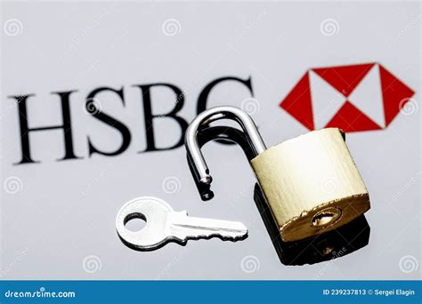 An Open Security Lock And Key On Background Of Hsbc Bank Logo In Mirror