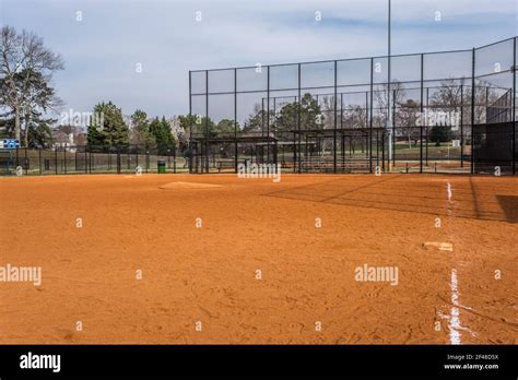 Empty baseball field at a local park opened for practice standing behind third base looking ...