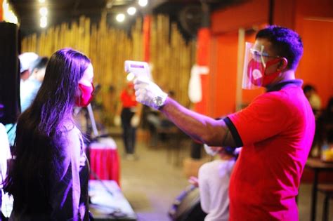 Premium Photo Side View Of Man Checking Woman Temperature While Standing On Land At Night