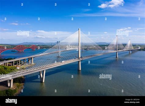 Aerial View Of Three Bridges Crossing The River Forth With New Queensferry Crossing In Front At