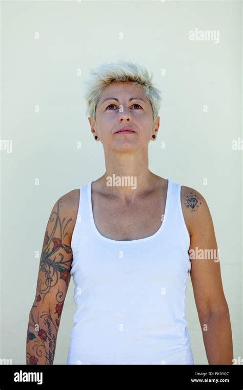 Blonde Woman With Flowered Tattoos On Her Arm Stock Photo Alamy