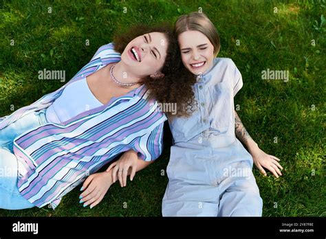 Two Young Women Enjoy Each Others Company Laughing Together While