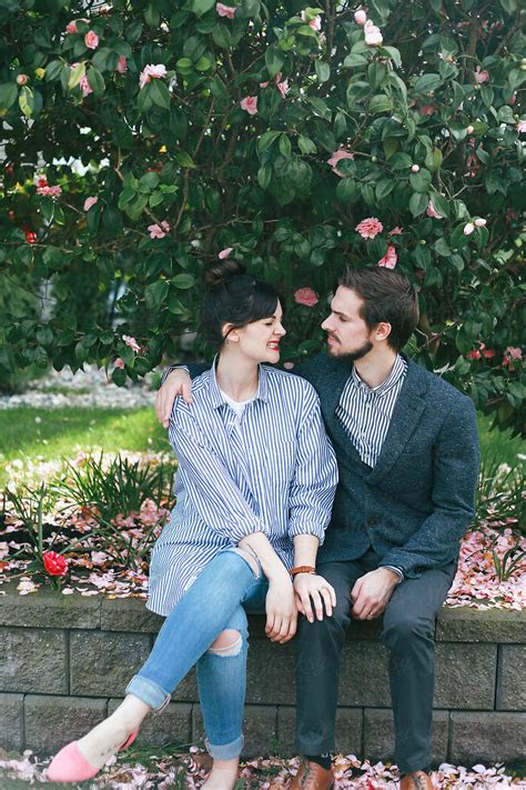 Couple In Love In Front Of A Flower Bush By Stocksy Contributor Pink
