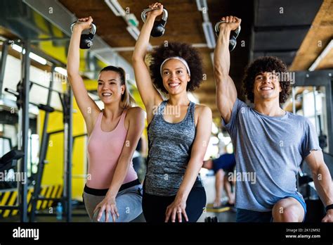 Group Of Fit People Lifting Dumbbells During An Exercise Class At The
