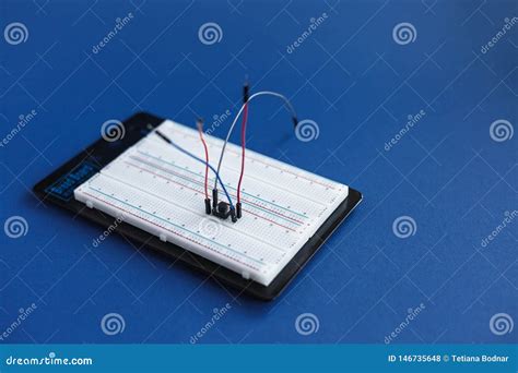 Breadboard And Microcontroller With Circuit And Light Sensor St Stock