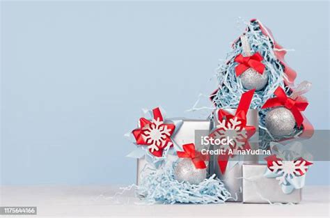 광고 및 디자인을위한 크리스마스 축제 배경 흰색 나무 테이블과 파란색 벽에 리본과 활 빛나는 공과 선물 상자 장식 빨간색과 파란색 전나무 나무 가벼운에 대한 스톡 사진 및