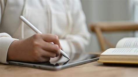 Premium Photo Closeup Image Of A Woman Holding A Stylus Pen Writing Or Taking Notes On Her