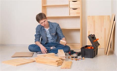 Premium Photo Puzzled Teenager Young Man Trying To Assemble Wooden