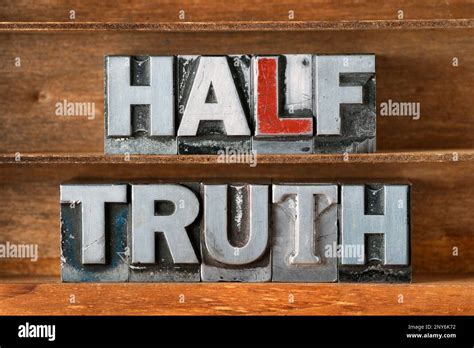 Half Truth Phrase Made From Metallic Letterpress Type On Wooden Tray