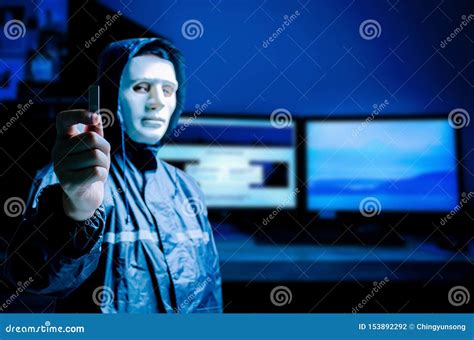 Anonymous Computer Hacker In White Mask And Hoodie Obscured Dark Face