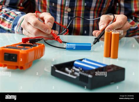 Electrician Measuring Battery Voltage With A Multimeter Home Master And Portable Power