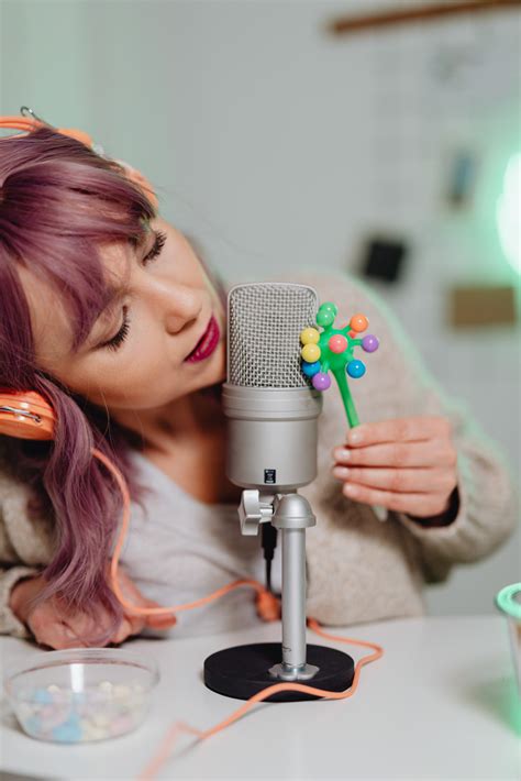 A Woman Recording On A Microphone Photos By Canva