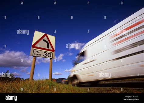 Van Passing Warning Sign Of Mph Speed Limit And Sharp Left Hand Bend In The Road Ahead