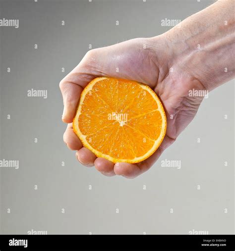 Hand squeezing orange juice hi-res stock photography and images - Alamy