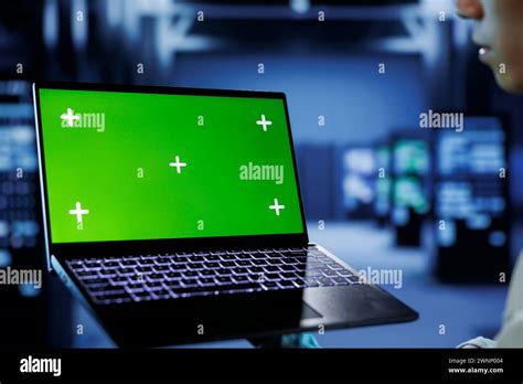 It Consultant With Chroma Key Laptop Between Server Hub Clusters