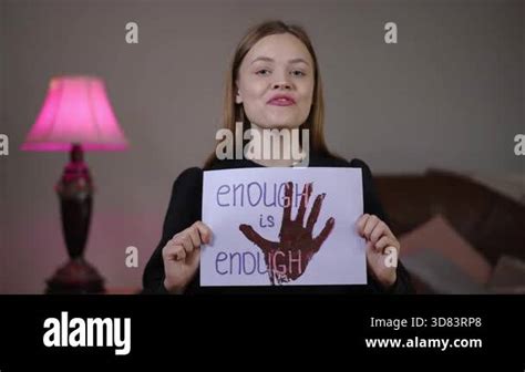 White Woman Holds Enough Is Enough Sign With Red Handprint Assertive