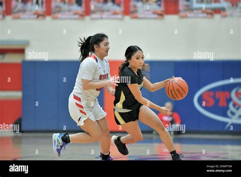 Usa Player Attempting To Drive Around An Opponent During A High School Varsity Basketball Game