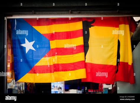 Catalan And Spanish Flags Hang Side By Side In A Las Ramblas Shop