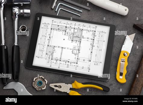 Tablet With Construction Tools And Blueprint Concept Stock Photo Alamy