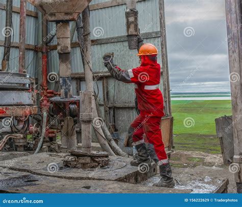A Working Driller Feeds Drill Pipes To Be Lowered Into The Well