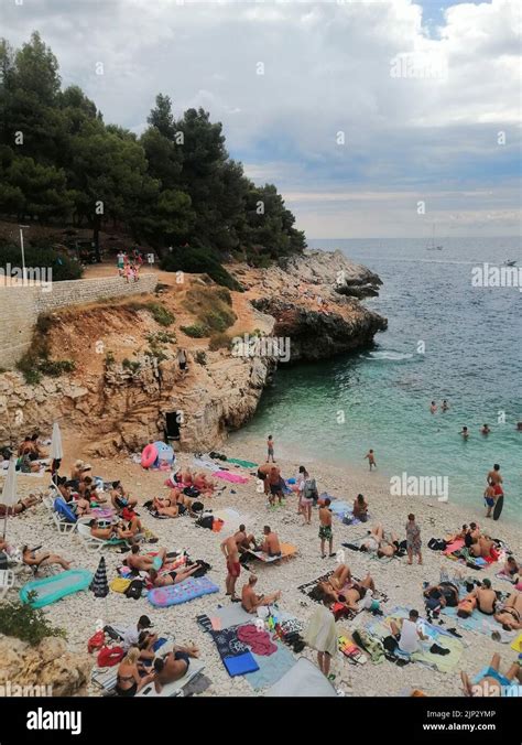 An Aerial View Of People Resting And Bathing By The Hawaii Beach On A Sunny Summer Day Stock