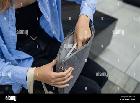 Female Hands Opening Fabric Backpack Putting Touchscreen Tablet And Laptop Computer Notebook