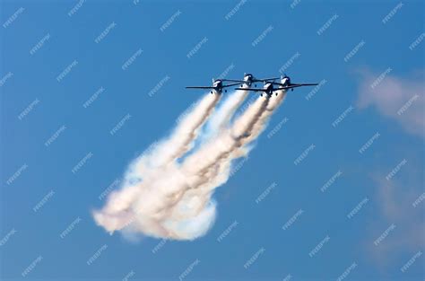 Premium Photo | Aerobatic team aircraft fighters trail of smoke in the sky.