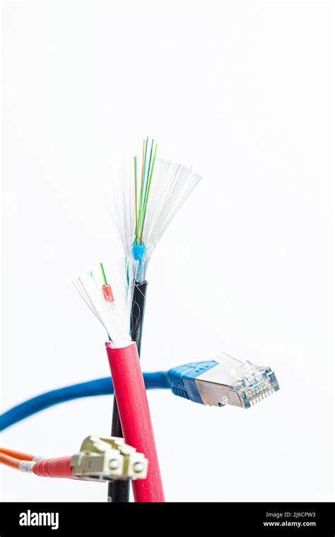 Cut Fiber Optic Cable With Fiber Optic Connectors And A Rj45 Patch Cord On A White Background