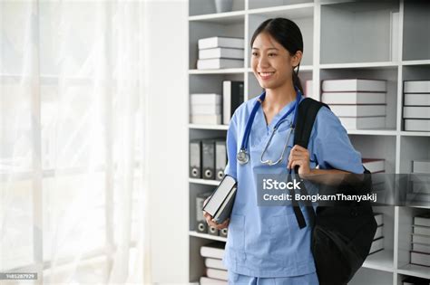 Young Asian Medical Student Smiling And Standing In The Study Room