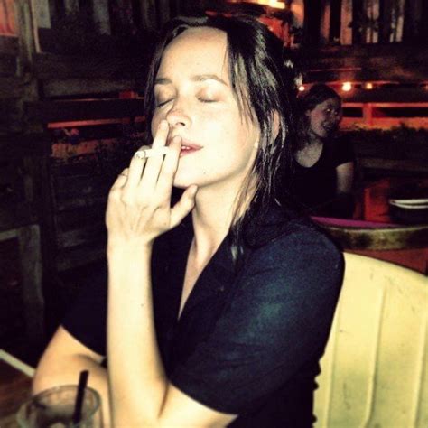 Dakota Johnson Smoking In Restaurant With Eyes Closed No Makeup Black Shirt Dress Dakota