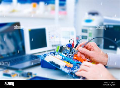 Repair Motherboard In Electronics Laboratory Technological Background With Closeup On Tester