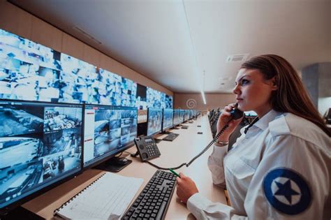 Female Security Operator Working In A Data System Control Room Offices