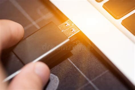 Hand Inserting USB Flash Memory Drive Plugged Into A Computer Laptop Port Stock Photo Image