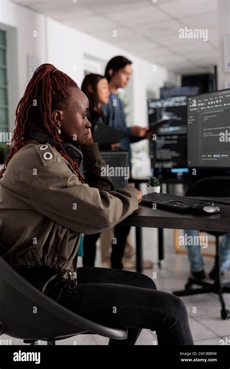 pensive african american app developer programming code development