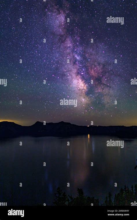 A Vertical Shot Of A Starry Sky Over Crater Lake In Oregon United