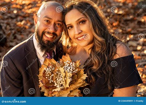 Romantic Photo Of A Well Dressed Mixed Race Couple Hugging And Holding