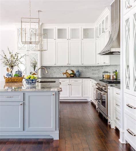 White Kitchen With A Light Blue Island Topped With A Gray And Blue