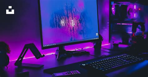 Black Flat Screen Computer Monitor Turned On Beside Black Computer