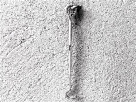 Premium Photo Close Up Of Hook Hanging From Wall