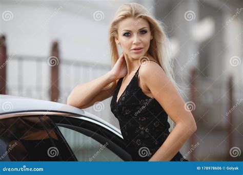 Portrait Of A Beautiful Blonde Girl Outdoors In Summer Near A Car Stock
