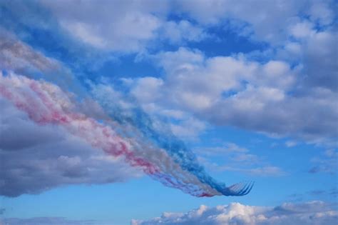Premium Photo Low Angle View Of Multi Colored Vapor Trails In Cloudy Sky