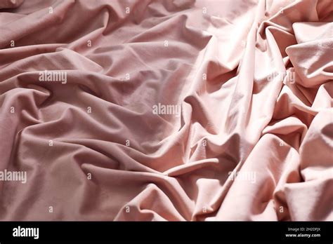 Pink Wrinkled Bedding With Morning Light Book And Candle Self Care