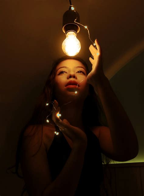 Woman Holding Lighted String Lights Photo Free Black Image On Unsplash