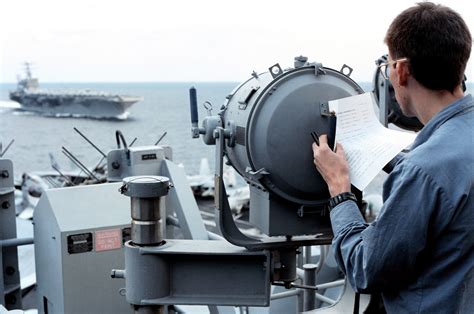 Signalman Second Class Petty Officer James Kennedy Flashes Morse Code