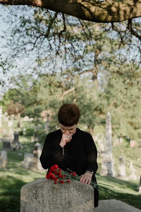 People Crying At A Grave