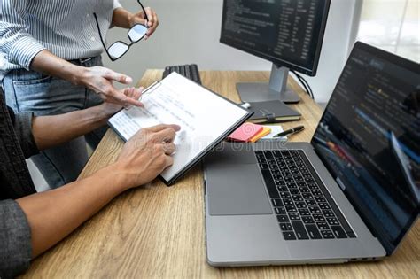 Two Professional Programmer Cooperating And Working On Web Site Project In A Software Developing
